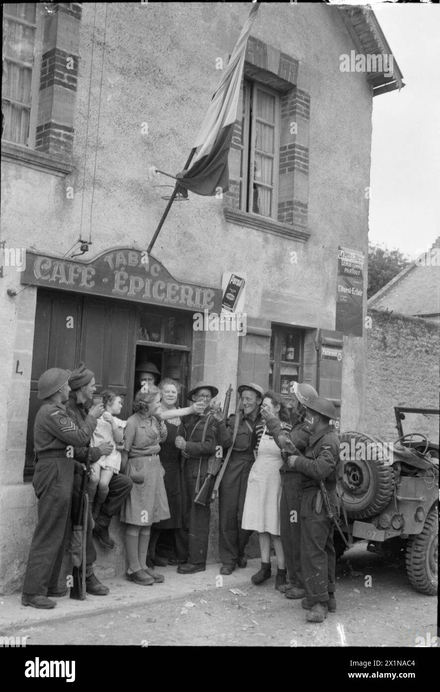 French civilians toast RAF airmen at a cafe in a small Norman village ...