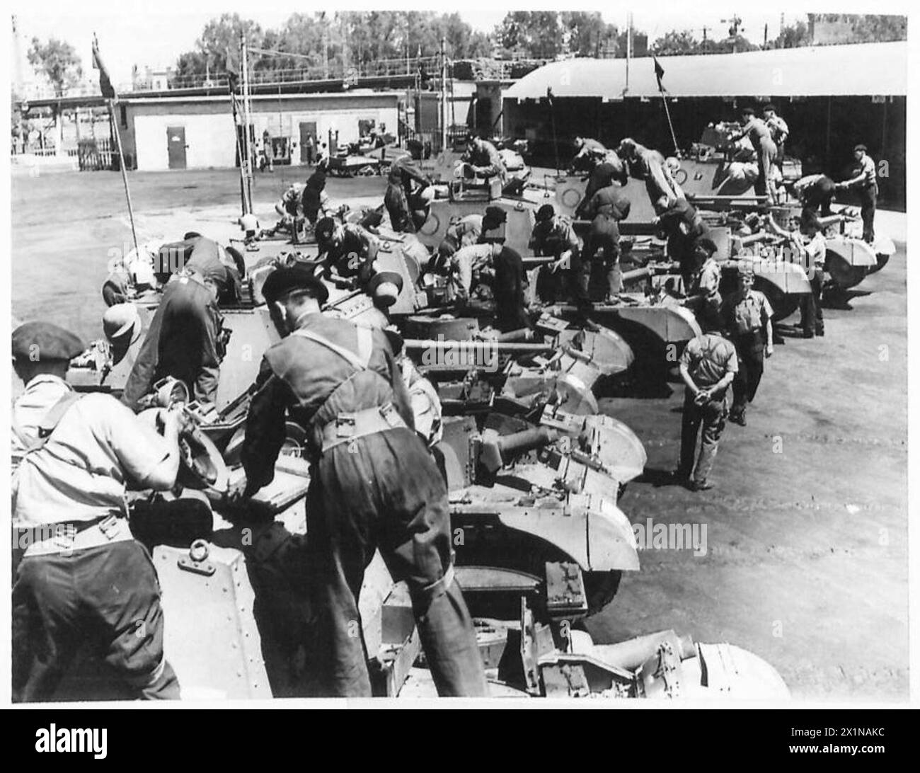 British Army tank crews in the desert perform final adjustments and ...