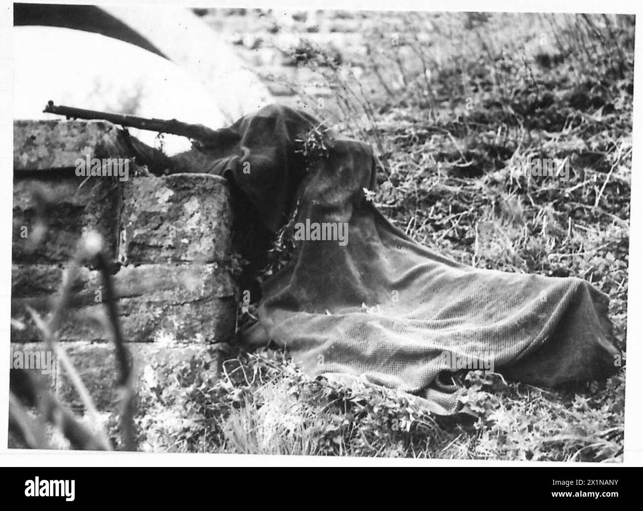 CLEARING A ROAD BLOCK - A camouflaged soldier covering the approach ...