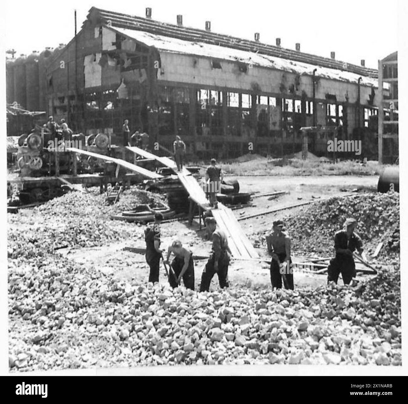 CAPTURED MATERIAL MAKES ROADS - A busy scene at the factory at Caen ...