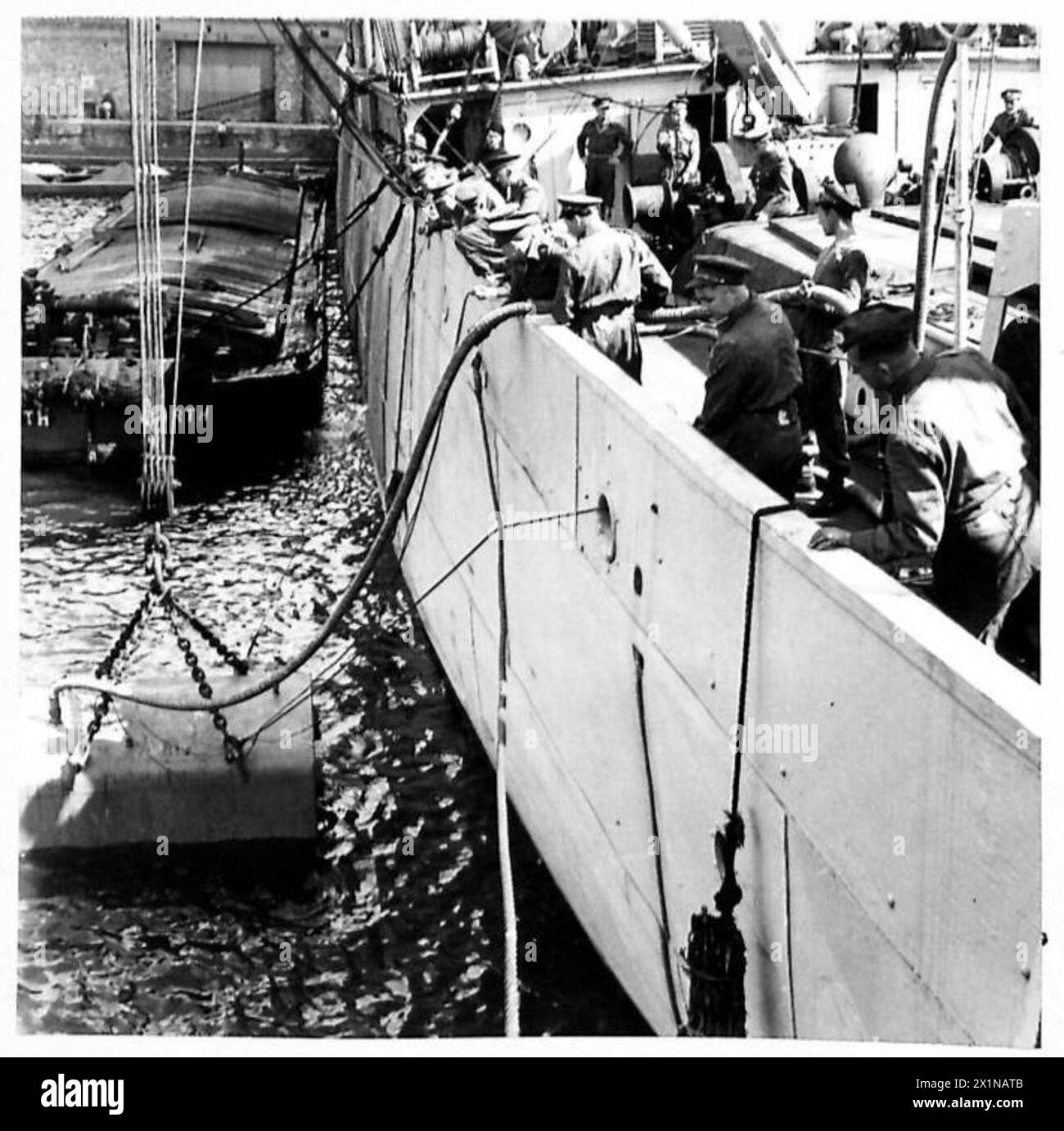REPAIR SHIP MANNED BY ROYAL ENGINEERS - The diving bell is lowered over ...