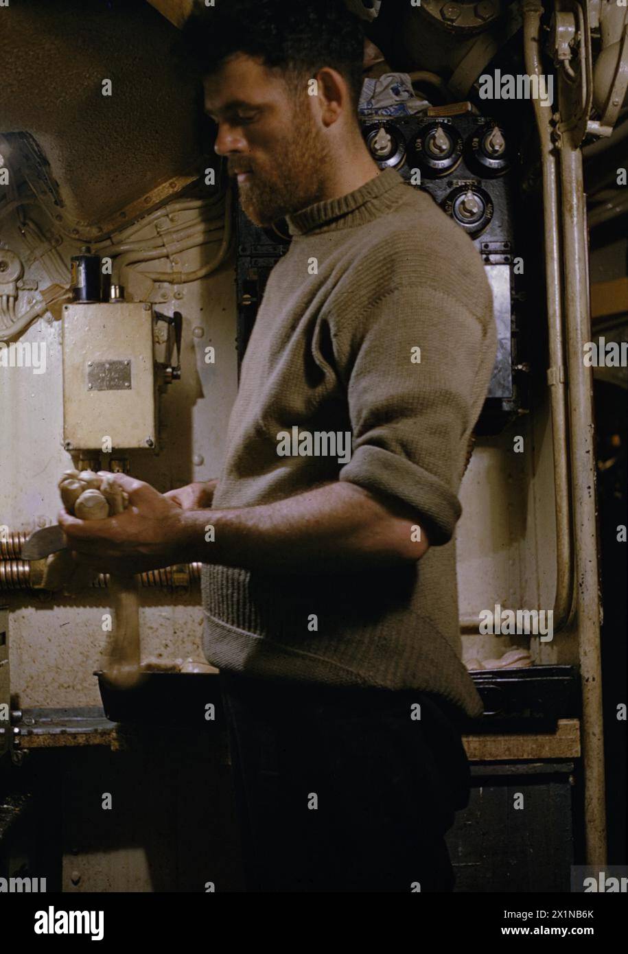 A Petty Officer Cook works aboard HMS Tribune, a Royal Navy submarine ...