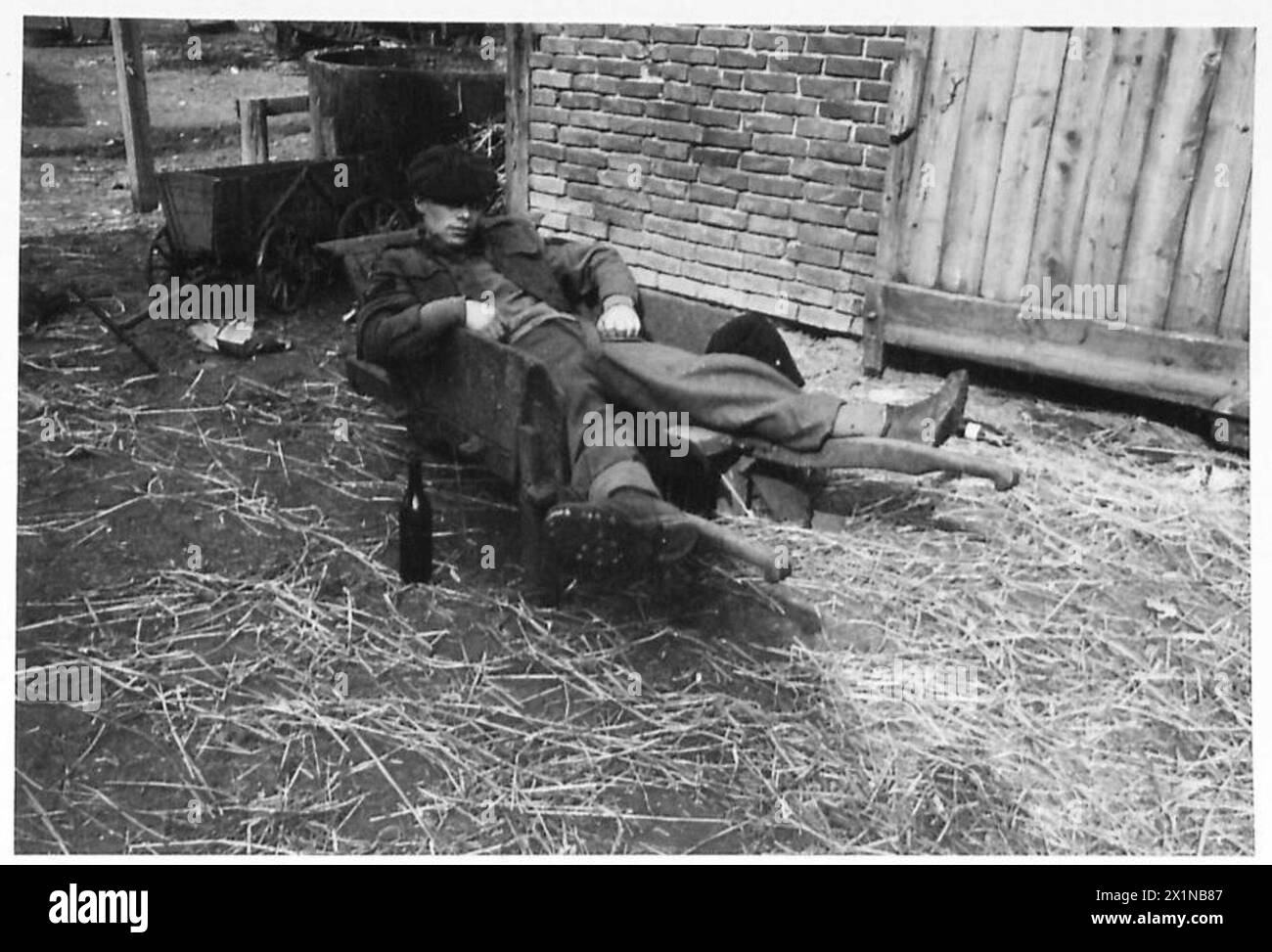 RHINE CROSSING - A tired Airborn soldier goes to sleep in a wheelbarrow ...