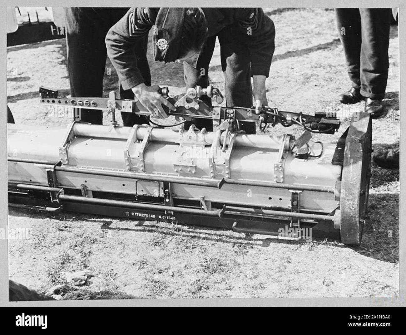 R.A.F. PERSONNEL PREPARING FIRE-BOMBS FOR USE IN RAIDS OVER ENEMY ...