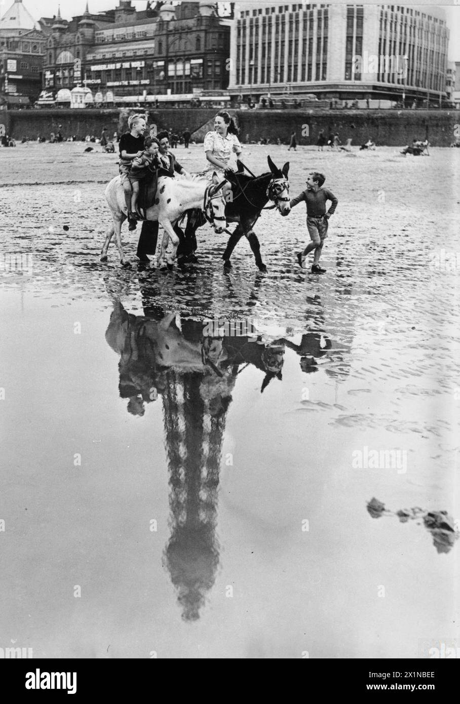 Civilians evacuated from London during WWII are shown riding donkeys ...