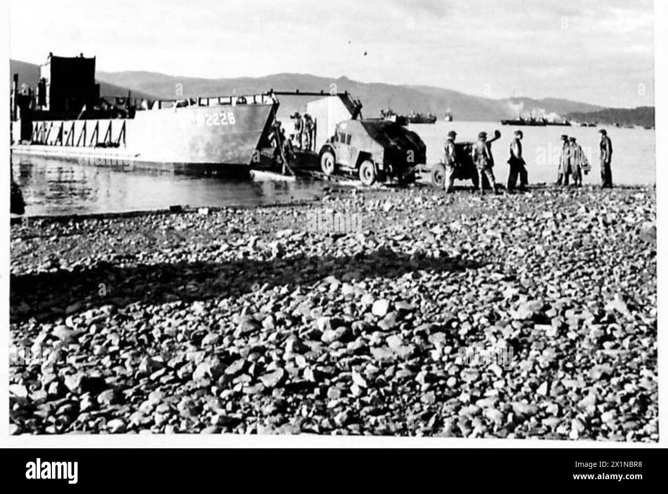 THE ARMY S OWN NAVY - 25-pdrs. being embarked on to an LCT for a beach ...