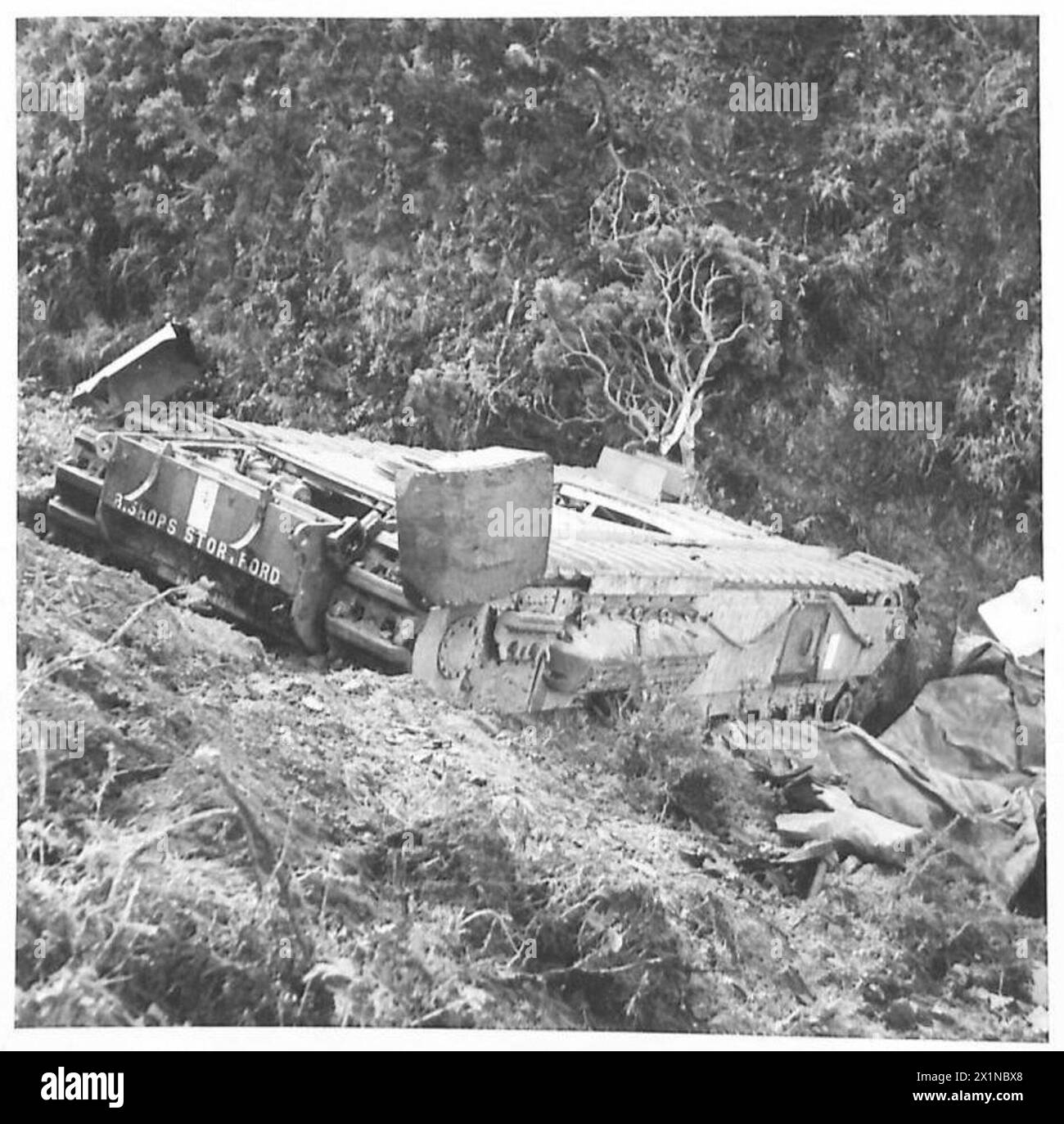 Damaged Churchill tanks are photographed at angles while British Army ...