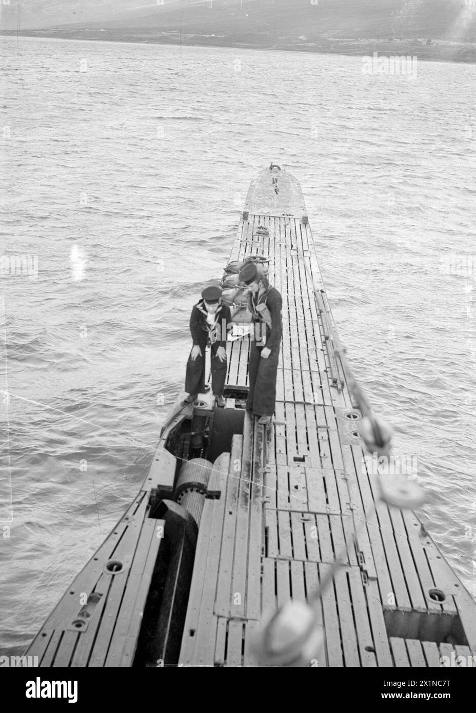 British sailors inspect surrendered U-boat Schnorkel equipment on deck ...