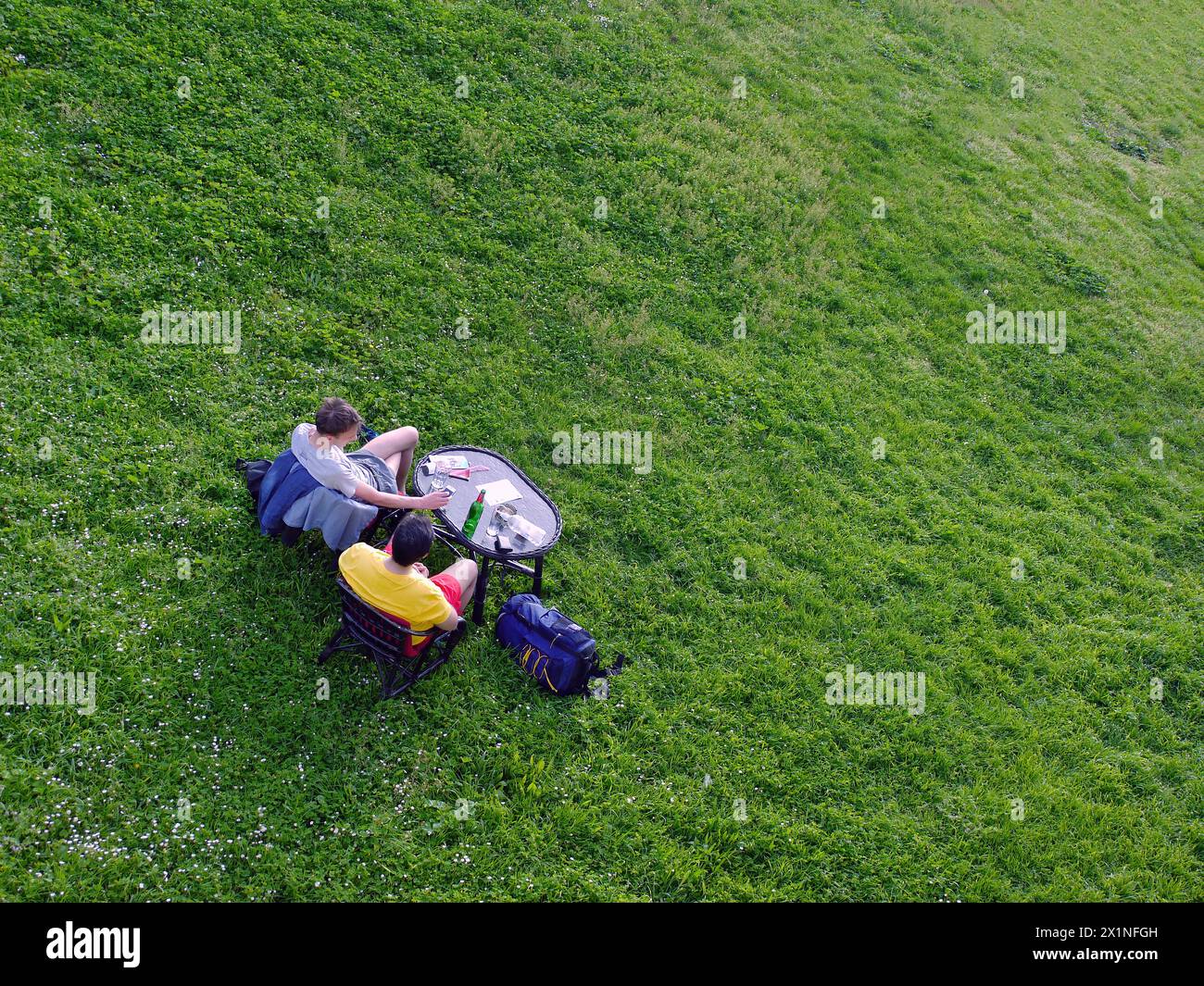 Aerial top view from above of two local people sitting resting and ...