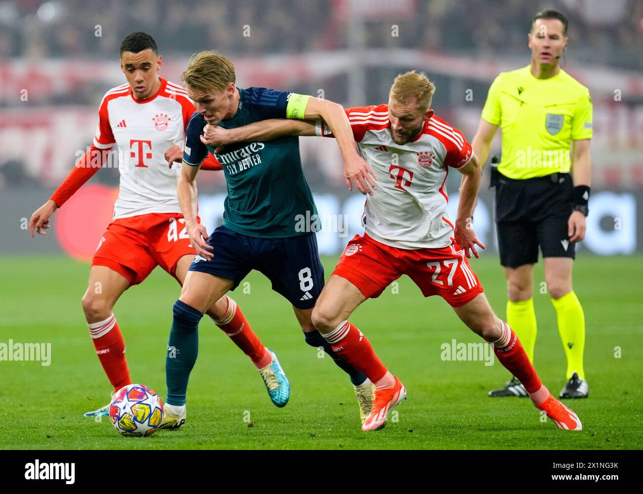 Arsenal's Martin Odegaard (centre left) battles for the ball with ...
