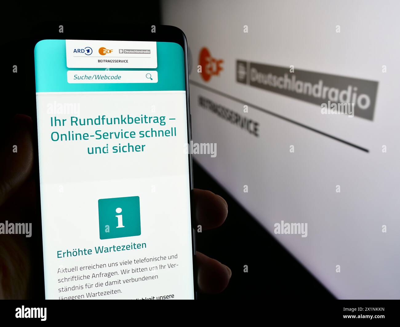 Person holding mobile phone with webpage of ARD ZDF Deutschlandradio ...