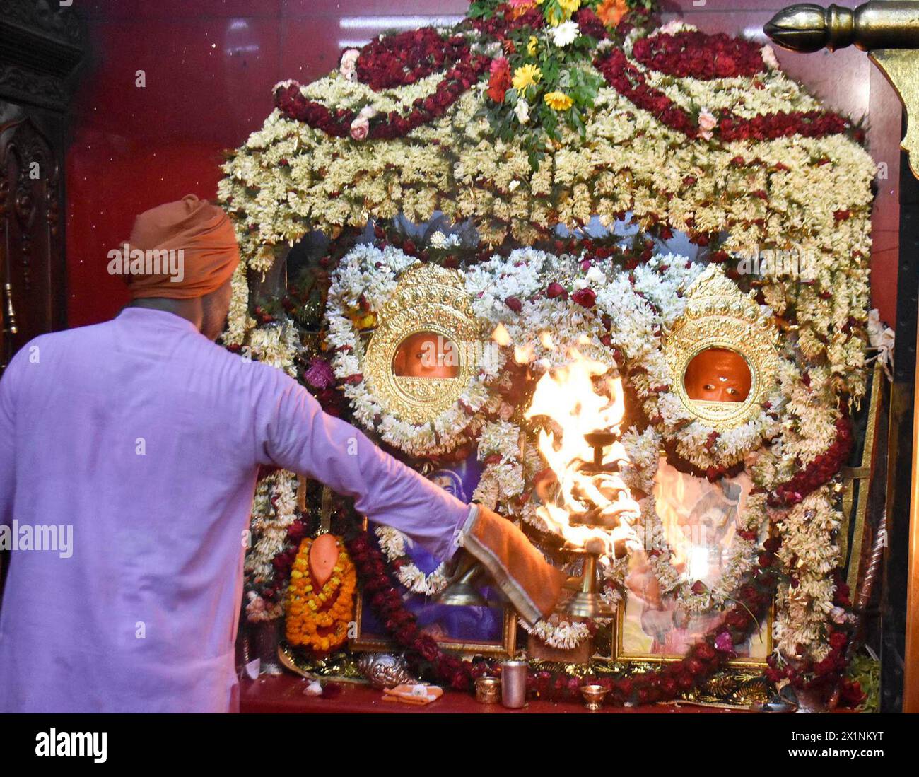 PATNA, INDIA - APRIL 17: A priest worshiping lord Hanuman at Mahavir ...