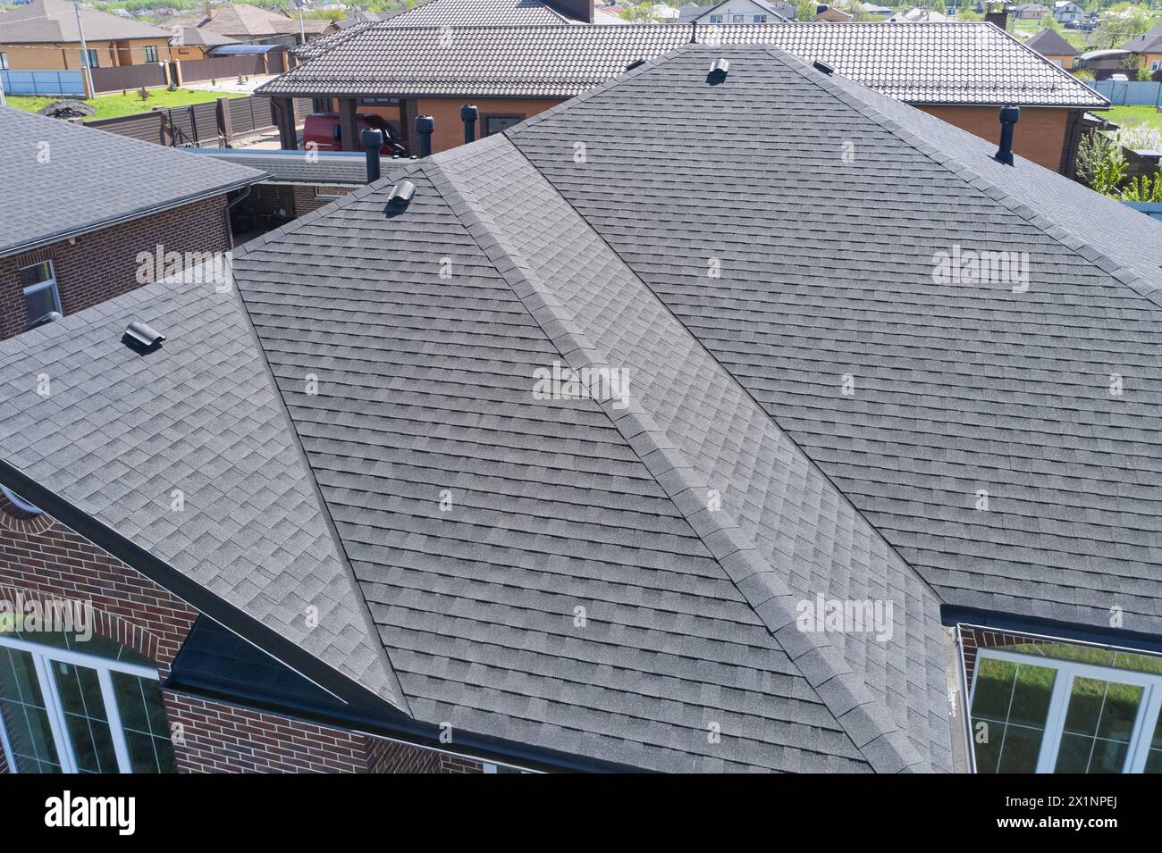 Luxury house roof with asphalt shingles Stock Photo - Alamy