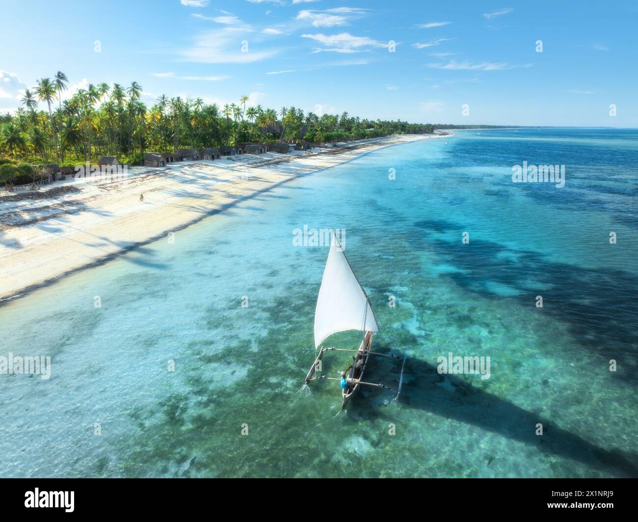 Aerial view of the sailboat on blue sea, empty white sandy beach Stock ...