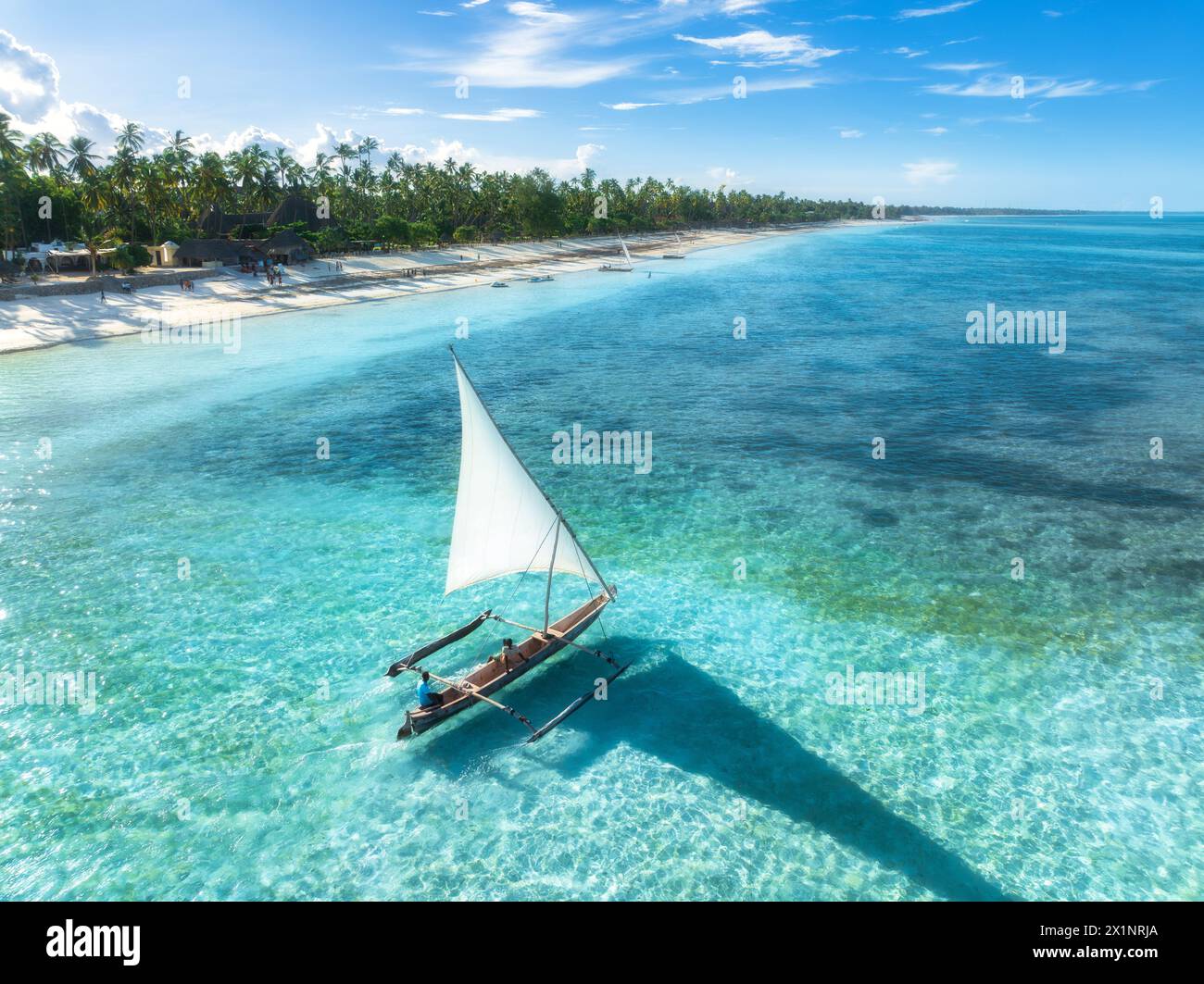 Aerial view of the sailboat on blue sea, empty white sandy beach Stock ...