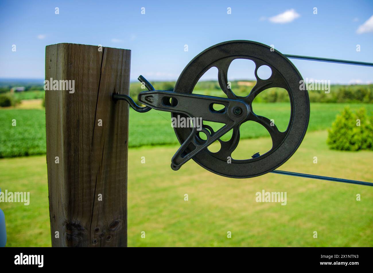 Metal Clothesline Wheel and Wood Post with landscape beyond Stock Photo ...