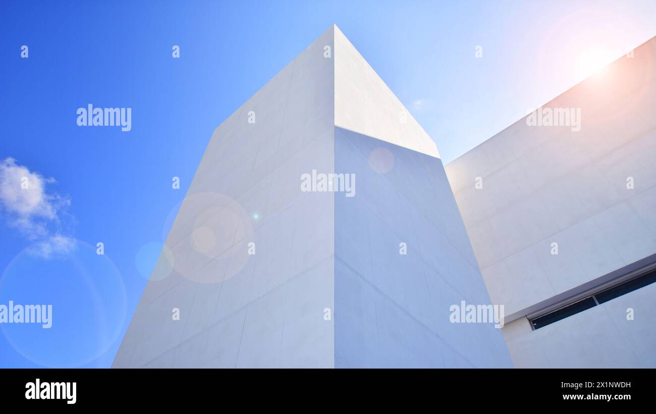 Sunlight and shadow on surface of white Concrete Building wall against ...