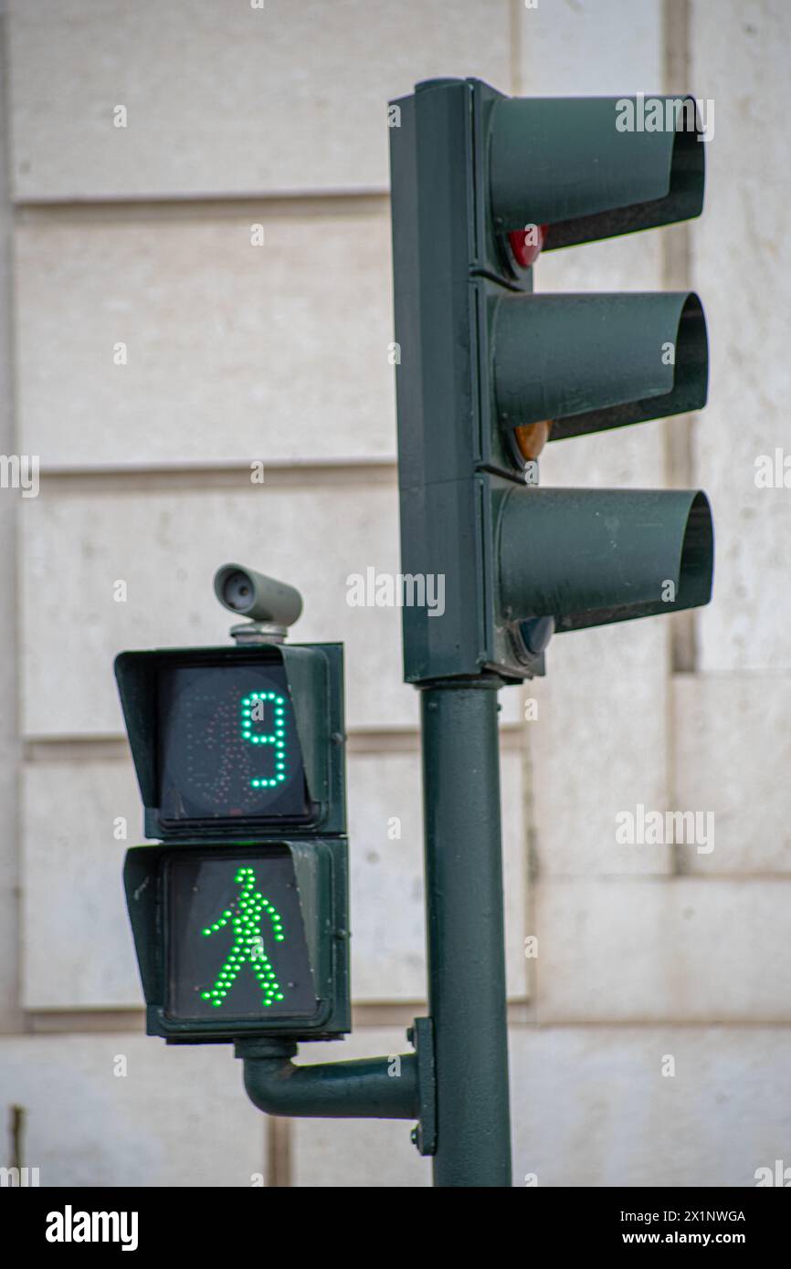 Green traffic light for pedestrians counting down in 9 seconds in ...