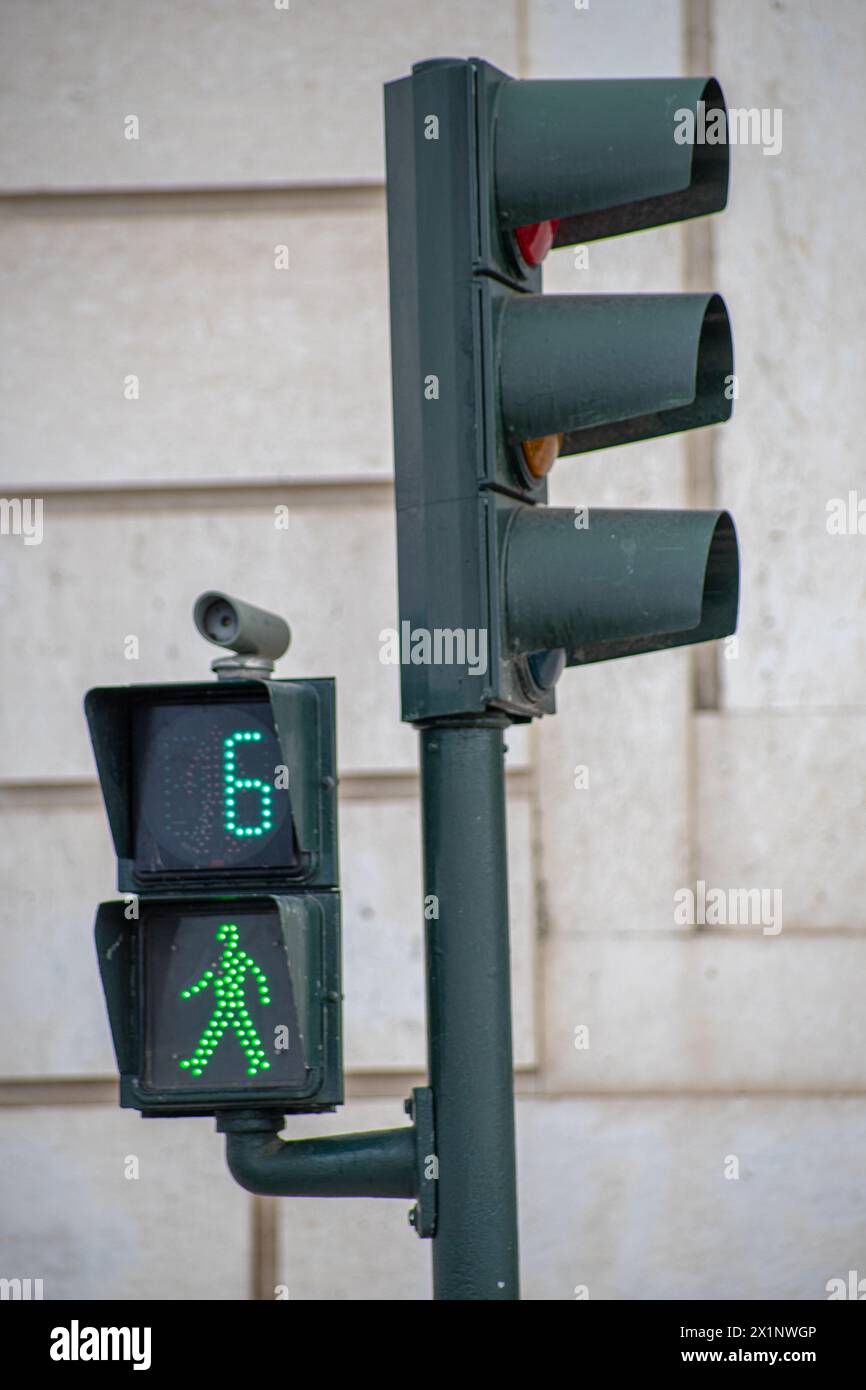 Green traffic light for pedestrians counting down in 6 seconds in ...