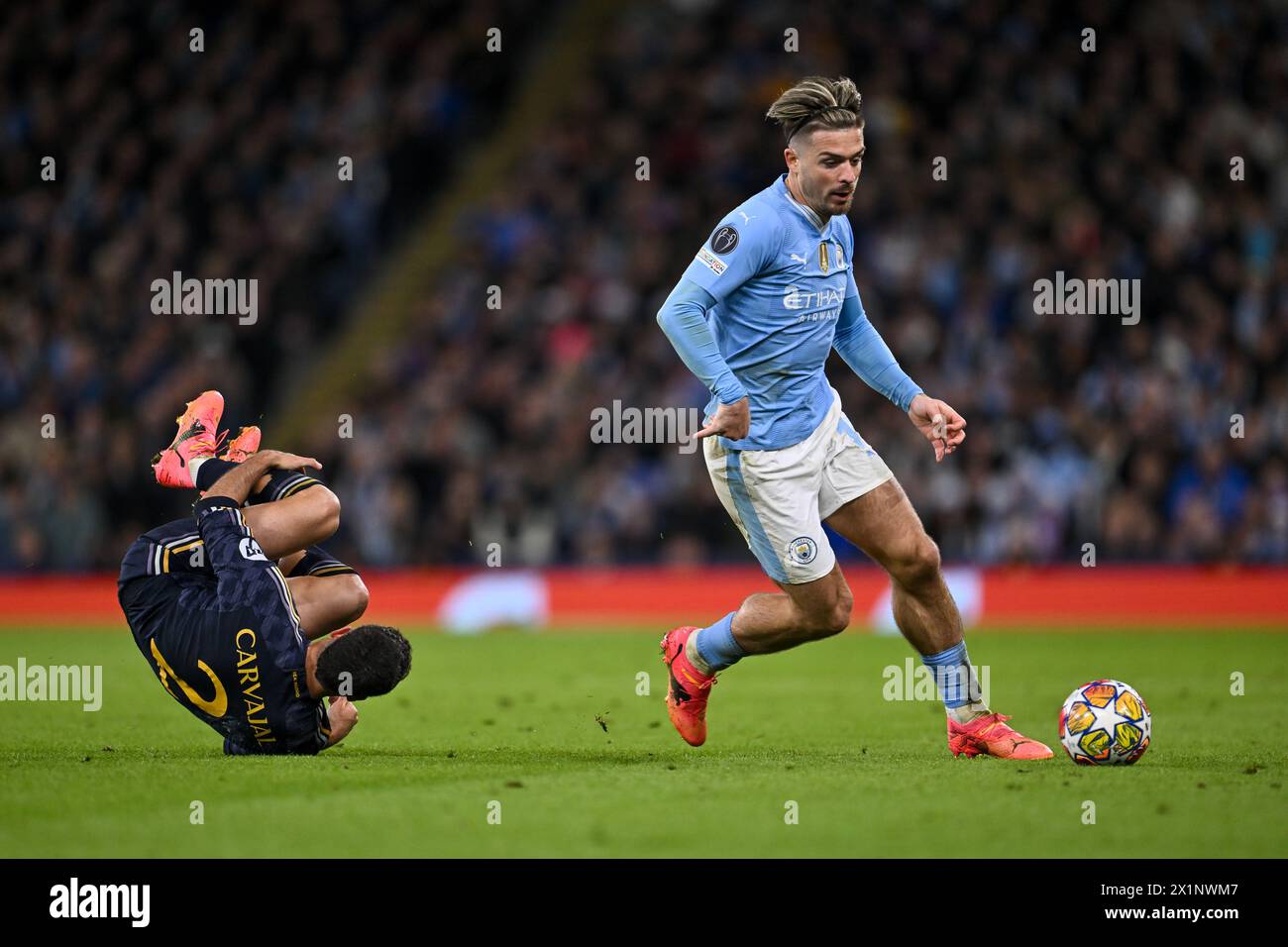 Jack Grealish of Manchester City runs with the ball as Dani Carvajal of ...