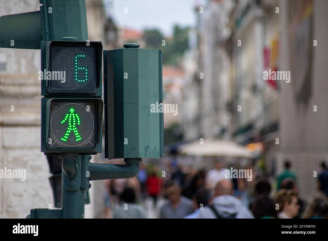 Green traffic light for pedestrians counting down in 6 seconds in ...