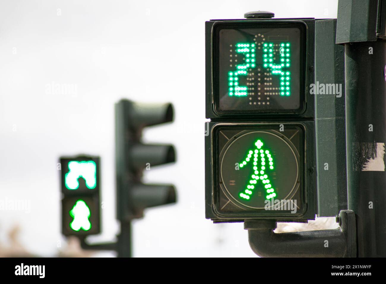 Green traffic light for pedestrians counting down in 24 seconds in ...