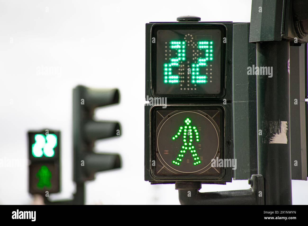 Green traffic light for pedestrians counting down in 22 seconds in ...