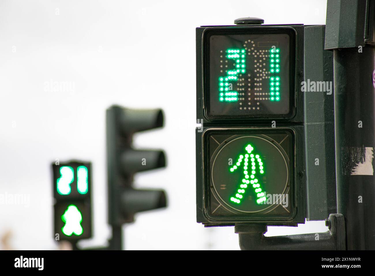 Green traffic light for pedestrians counting down in 21 seconds in ...