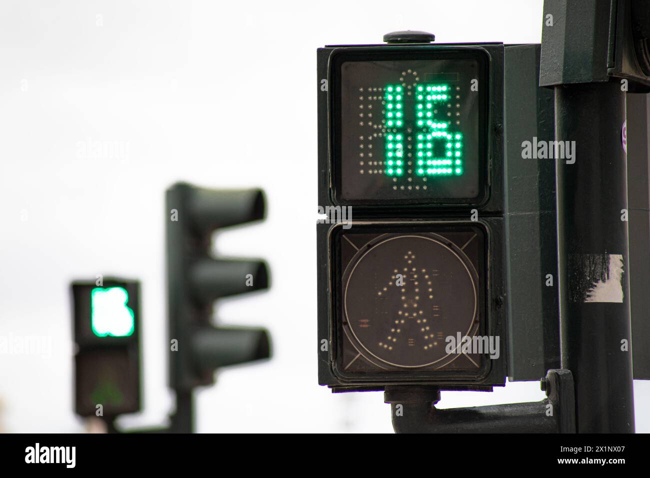 Green traffic light for pedestrians counting down in 16 seconds in ...