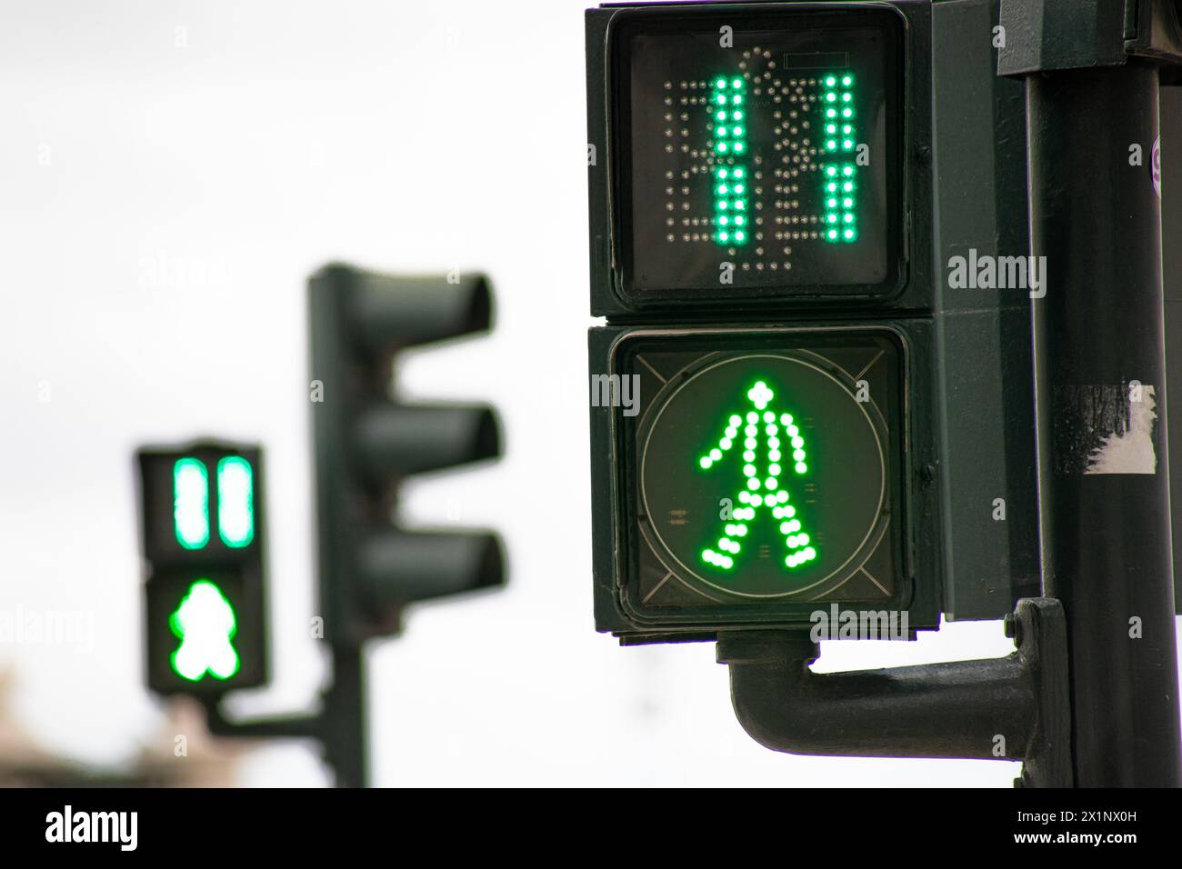 Green traffic light for pedestrians counting down in 11 seconds in ...