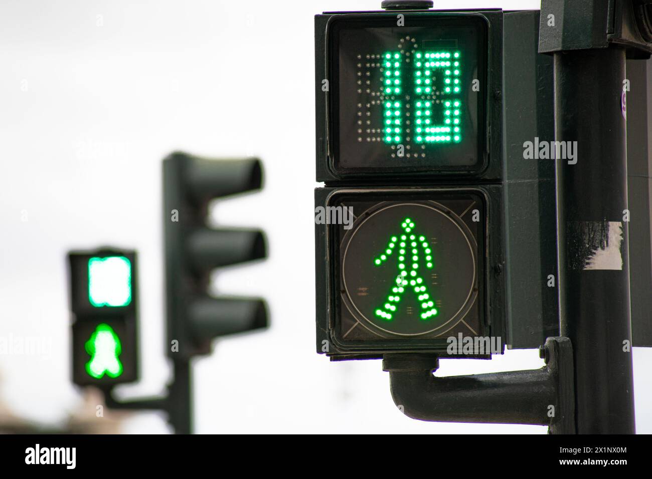 Green traffic light for pedestrians counting down in 10 seconds in ...