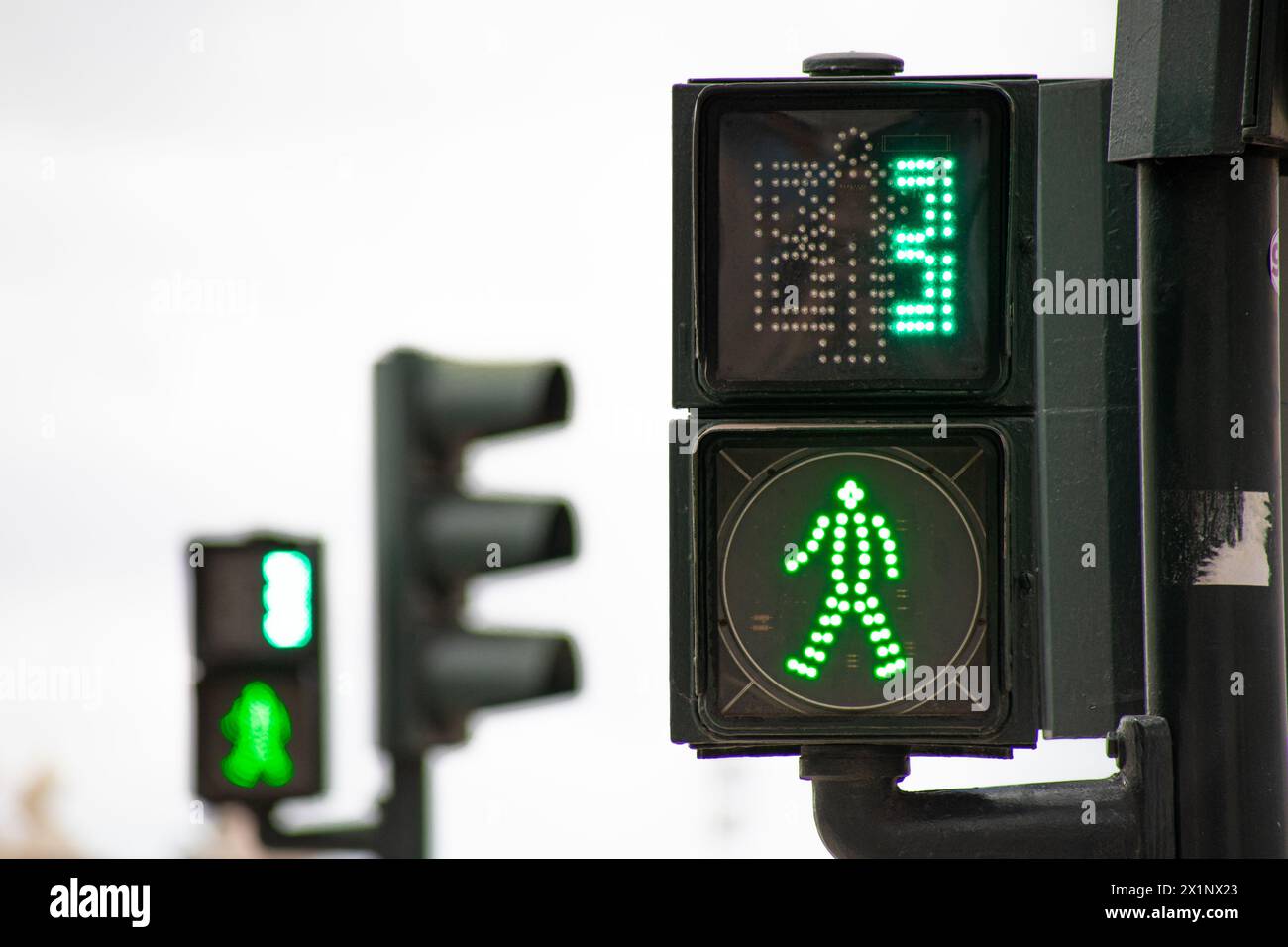 Green traffic light for pedestrians counting down in 3 seconds in ...