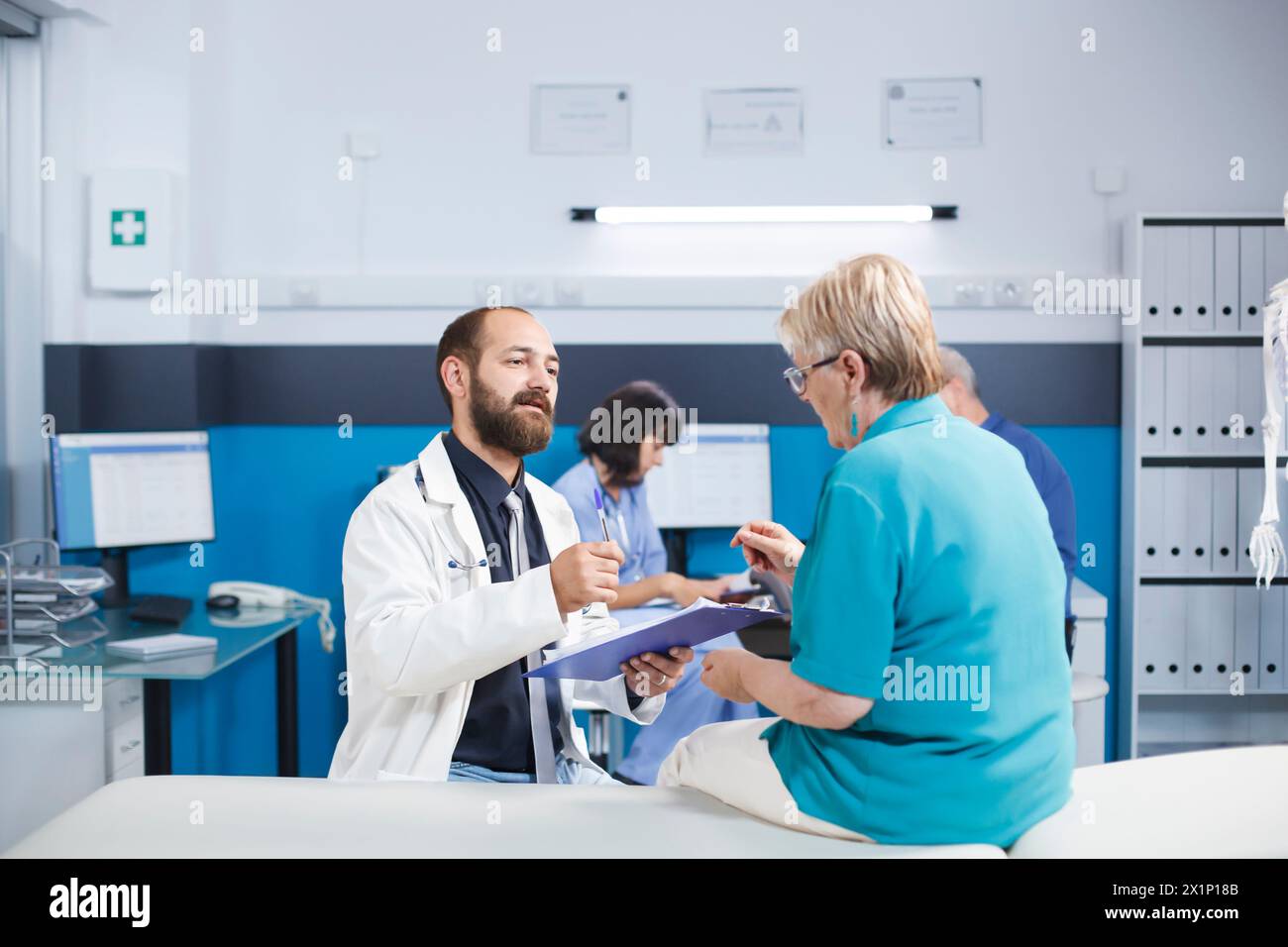 Senior patient consulting with a physiotherapist for back pain ...