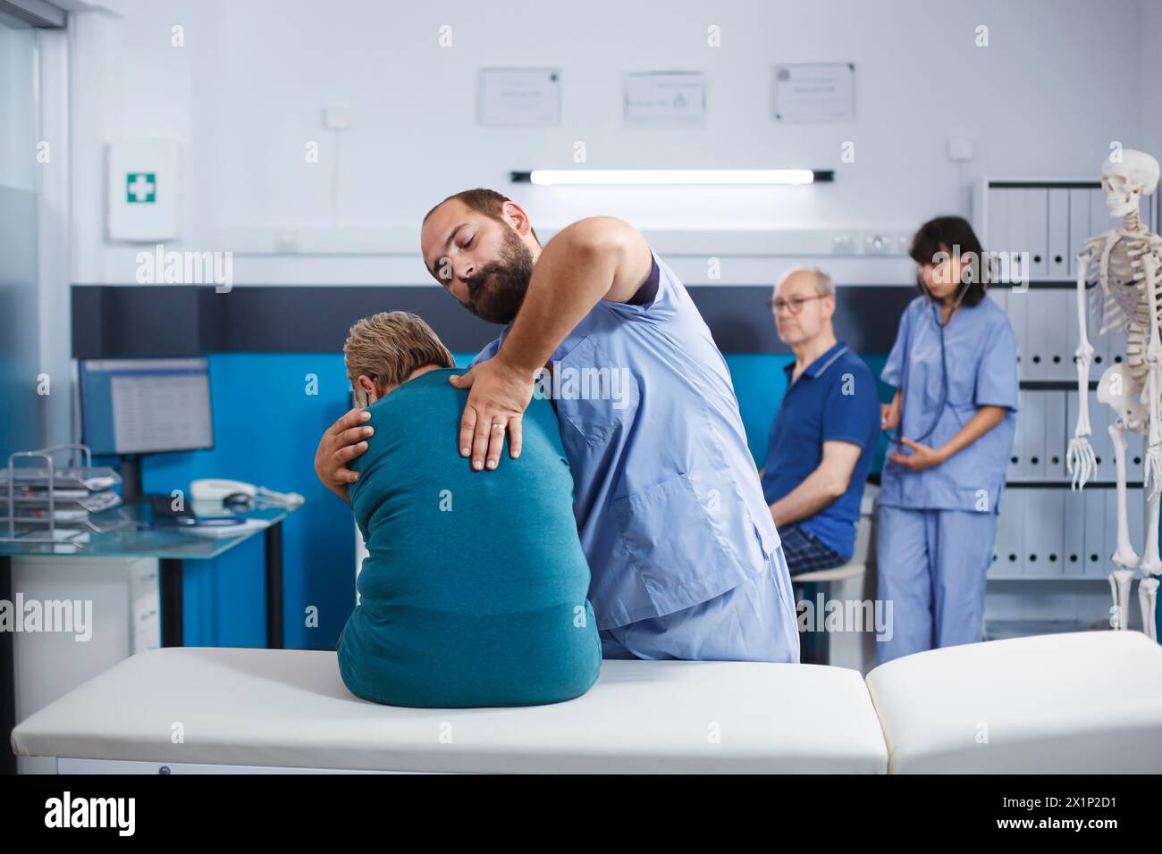 Chiropractor assistant helping patient hi-res stock photography and ...