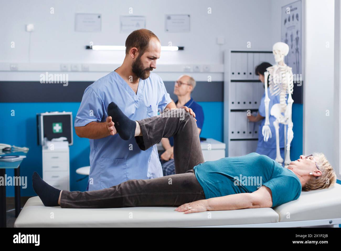 Physiotherapist stretching leg muscle to relieve pressure for recovery ...