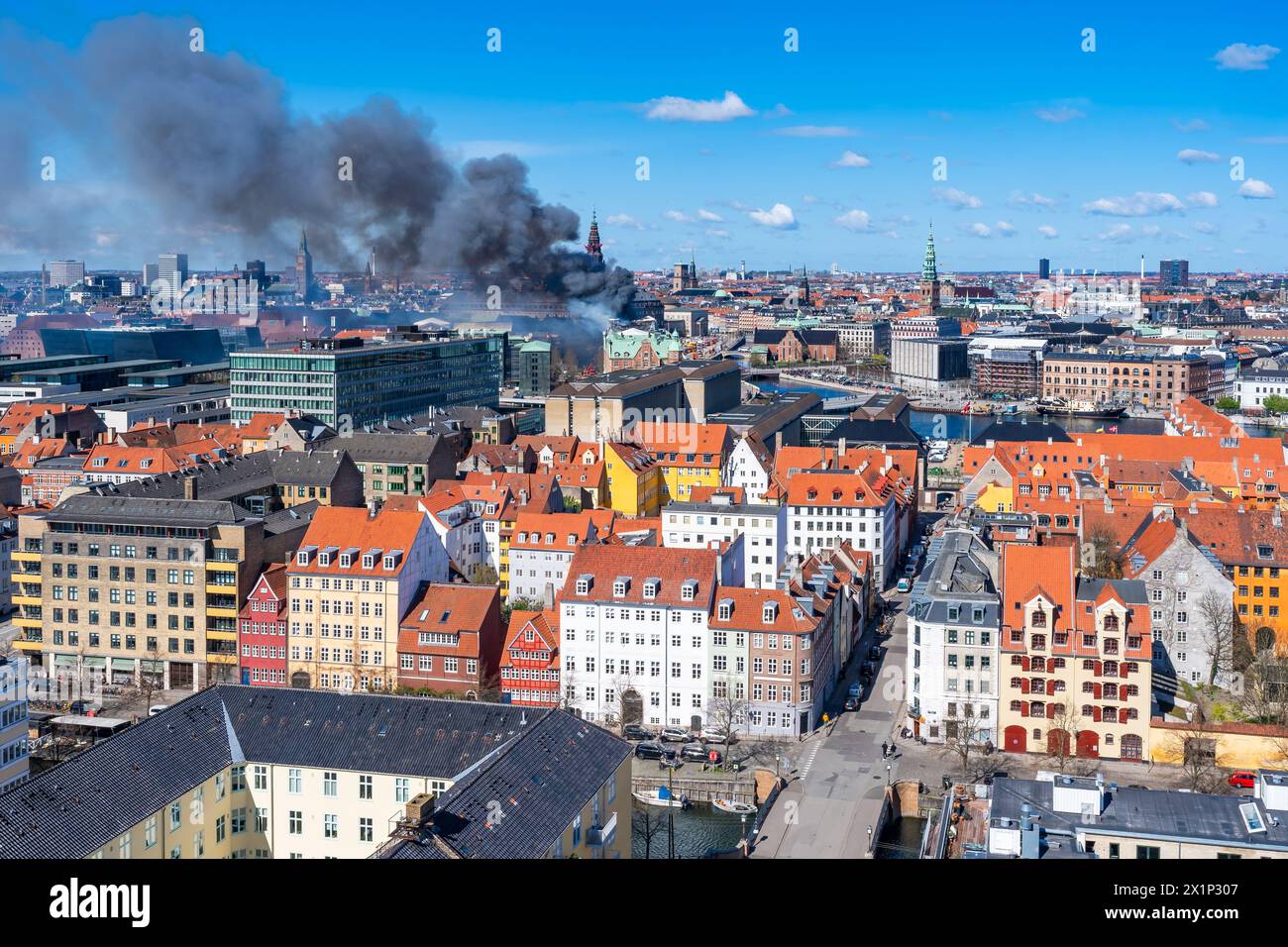 COPENHAGEN, DENMARK - APRIL 16, 2024: Black smoke drifts over central ...