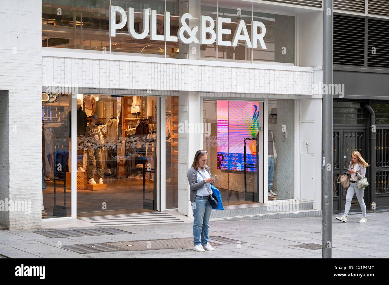 A woman is seen outside the Spanish multinational clothing design retail company by Inditex ...