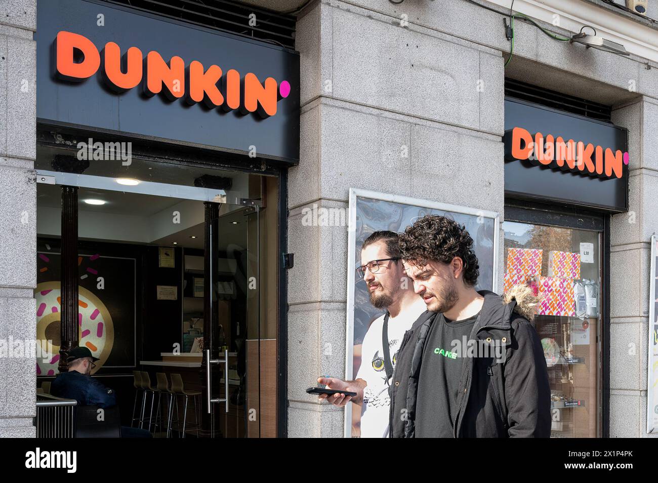 Pedestrians walk past the American chain of fast-food restaurants Taco ...
