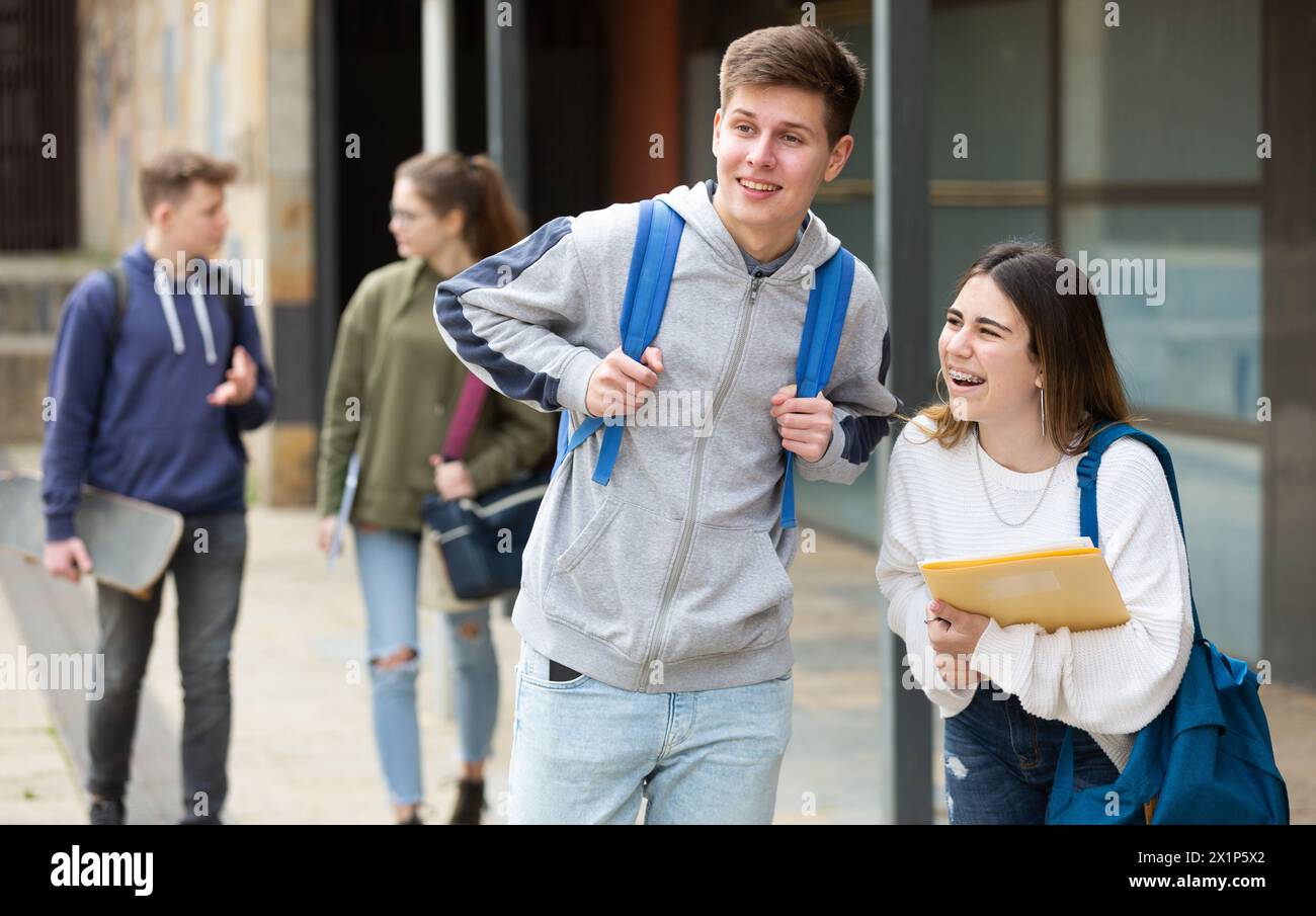 Carefree teen students boy and girl friendly talking Stock Photo - Alamy
