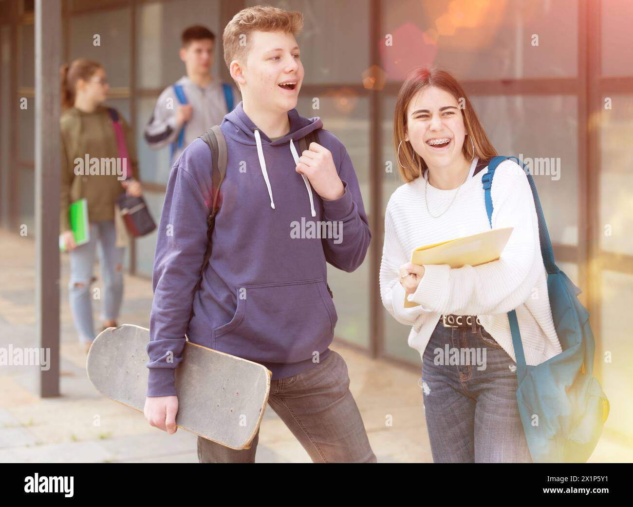 Cheerful teenagers talking outside after lessons Stock Photo - Alamy