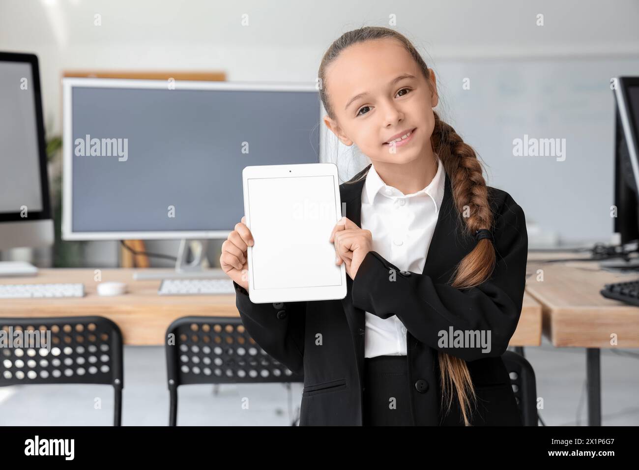 Little girl with tablet at school computer lab Stock Photo - Alamy