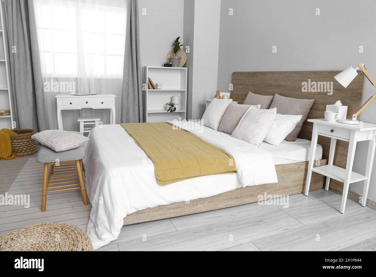 Interior of light modern bedroom with big bed, window, shelving units ...