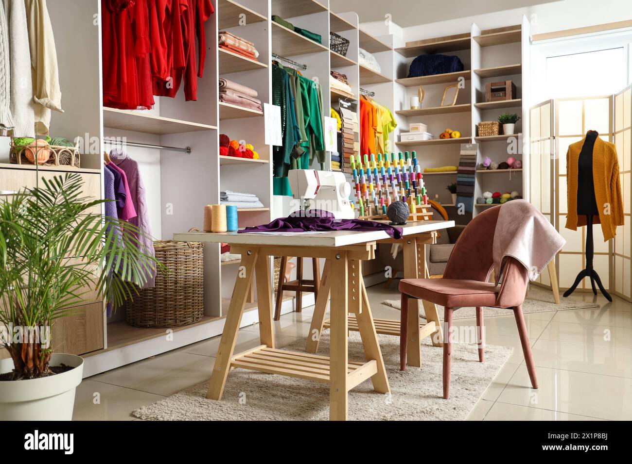 Interior of atelier with tailor's workplace and shelves Stock Photo - Alamy