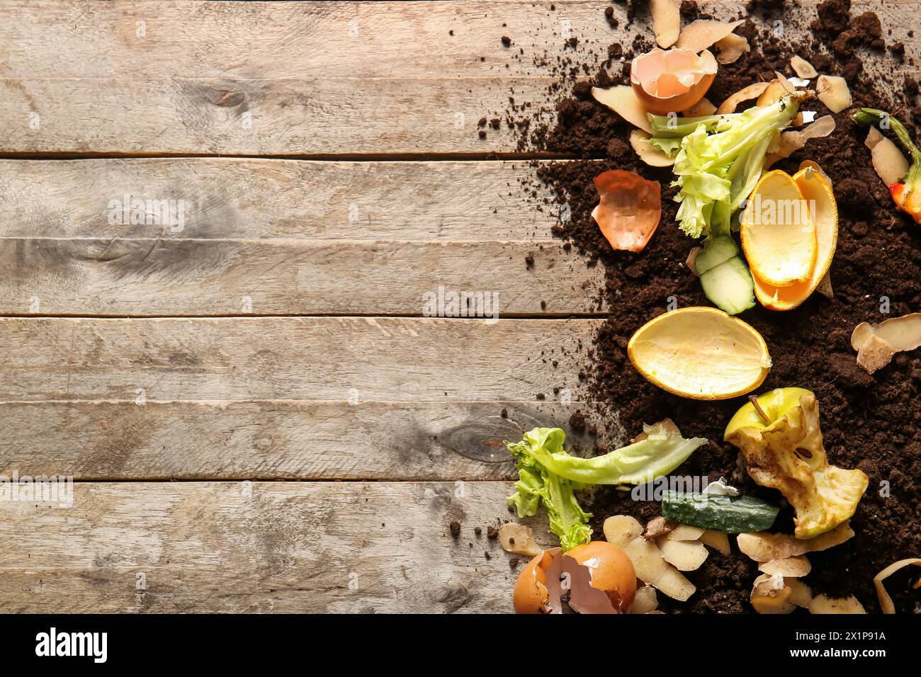 Organic waste and soil on wooden background. Compost recycling concept ...