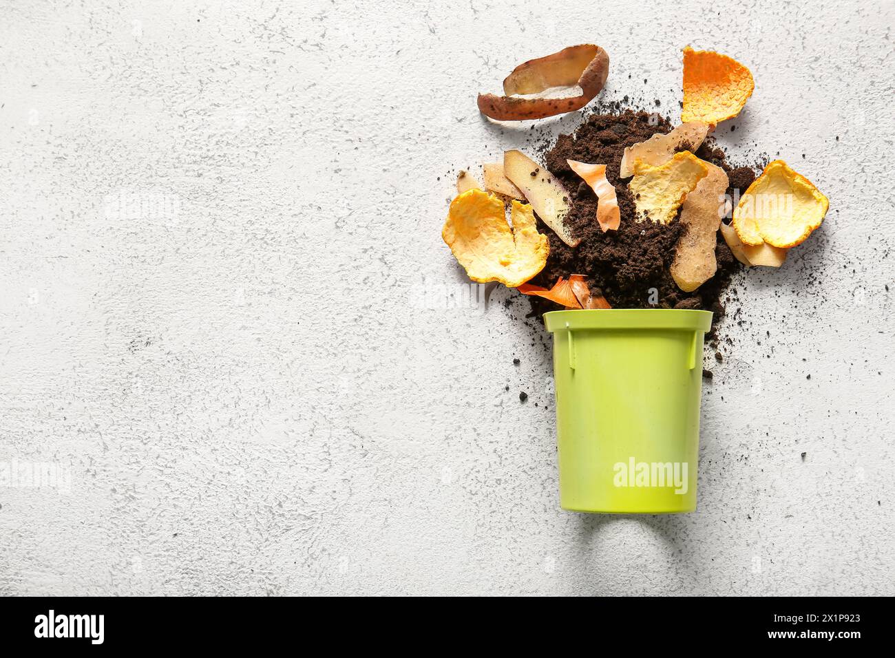 Bin with organic waste and soil on white grunge background. Compost ...