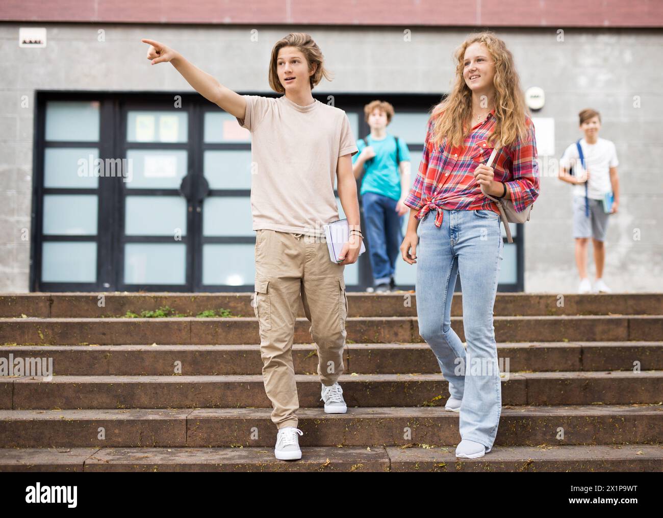 Boy and girl walking home after finishing lessons Stock Photo - Alamy