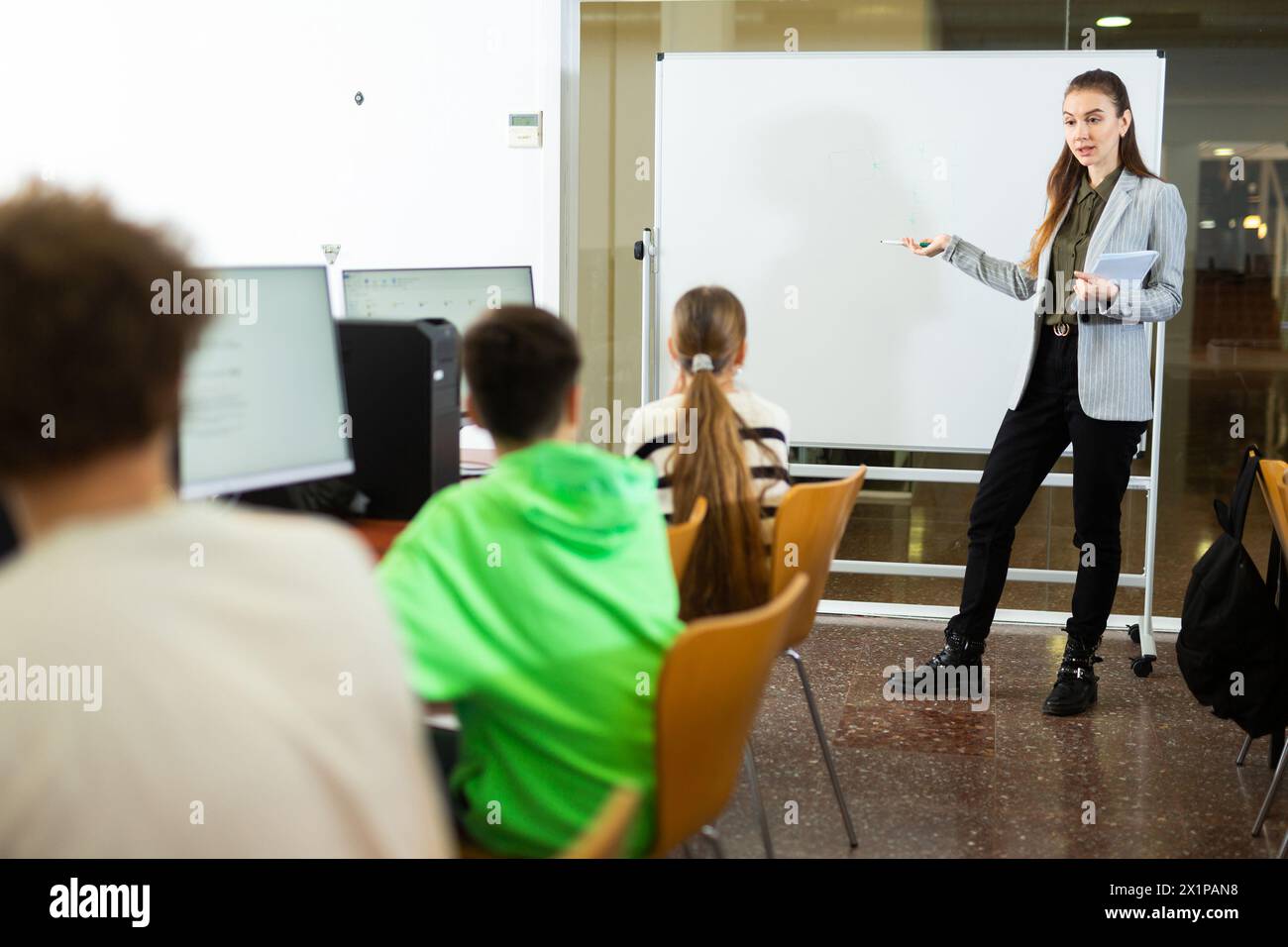 Portrait of schoolgirl at computers in university computer class Stock ...