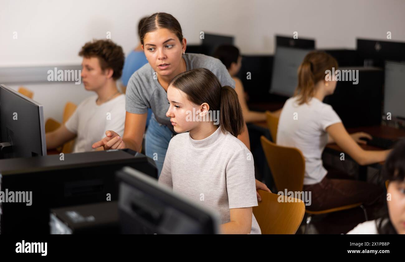 Teacher and teenage girl studying computer science Stock Photo - Alamy