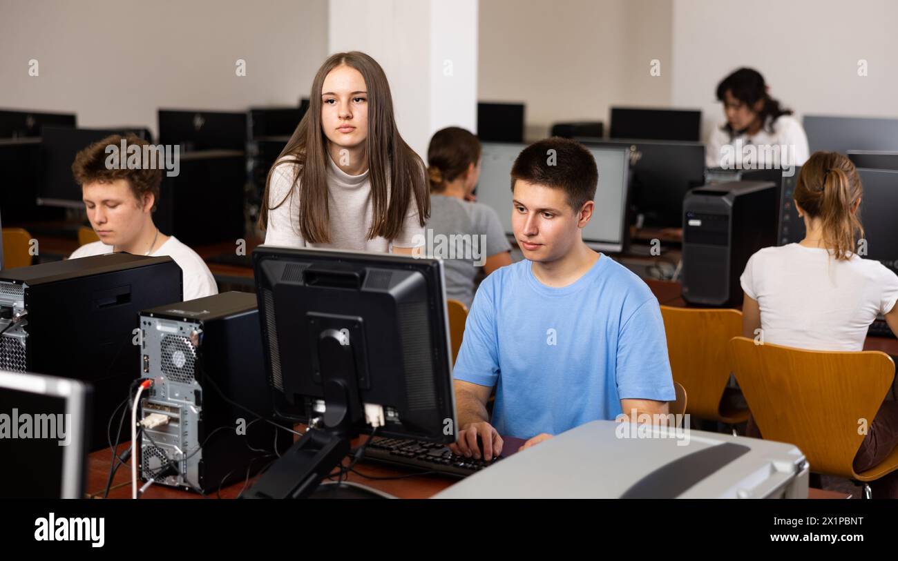 Teenager boy and girl studying in computer class Stock Photo - Alamy