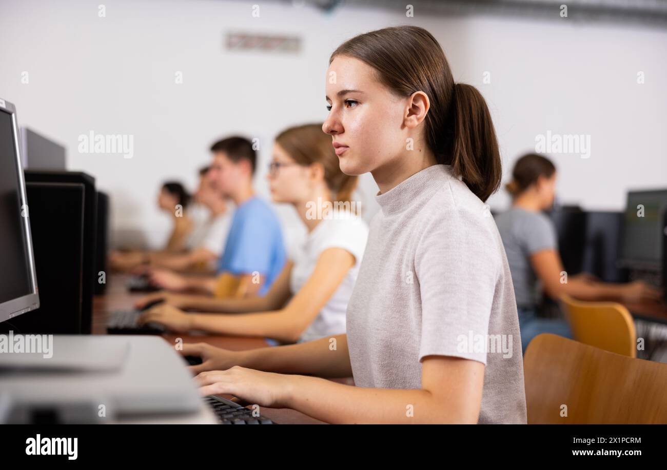 Teenage girl learning to use personal computer during lesson Stock ...